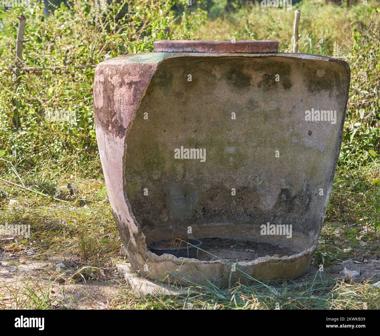 A large traditional damaged water jar on na farm in rural Thailand ...