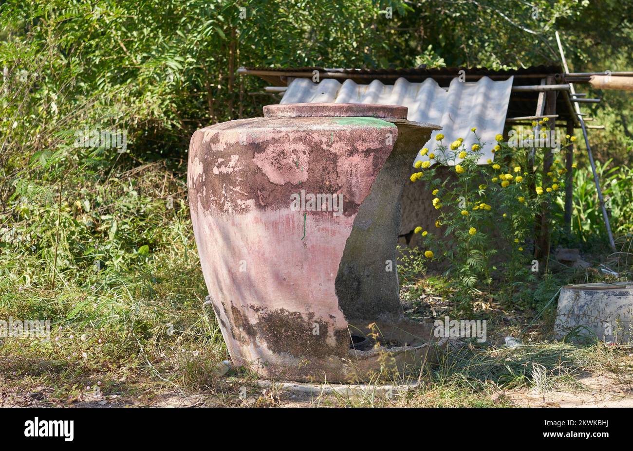 A large traditional damaged water jar on na farm in rural Thailand ...