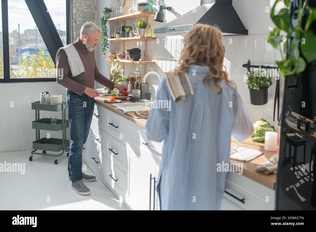 Gray-haired mature man cooking in the kitchen Stock Photo - Alamy