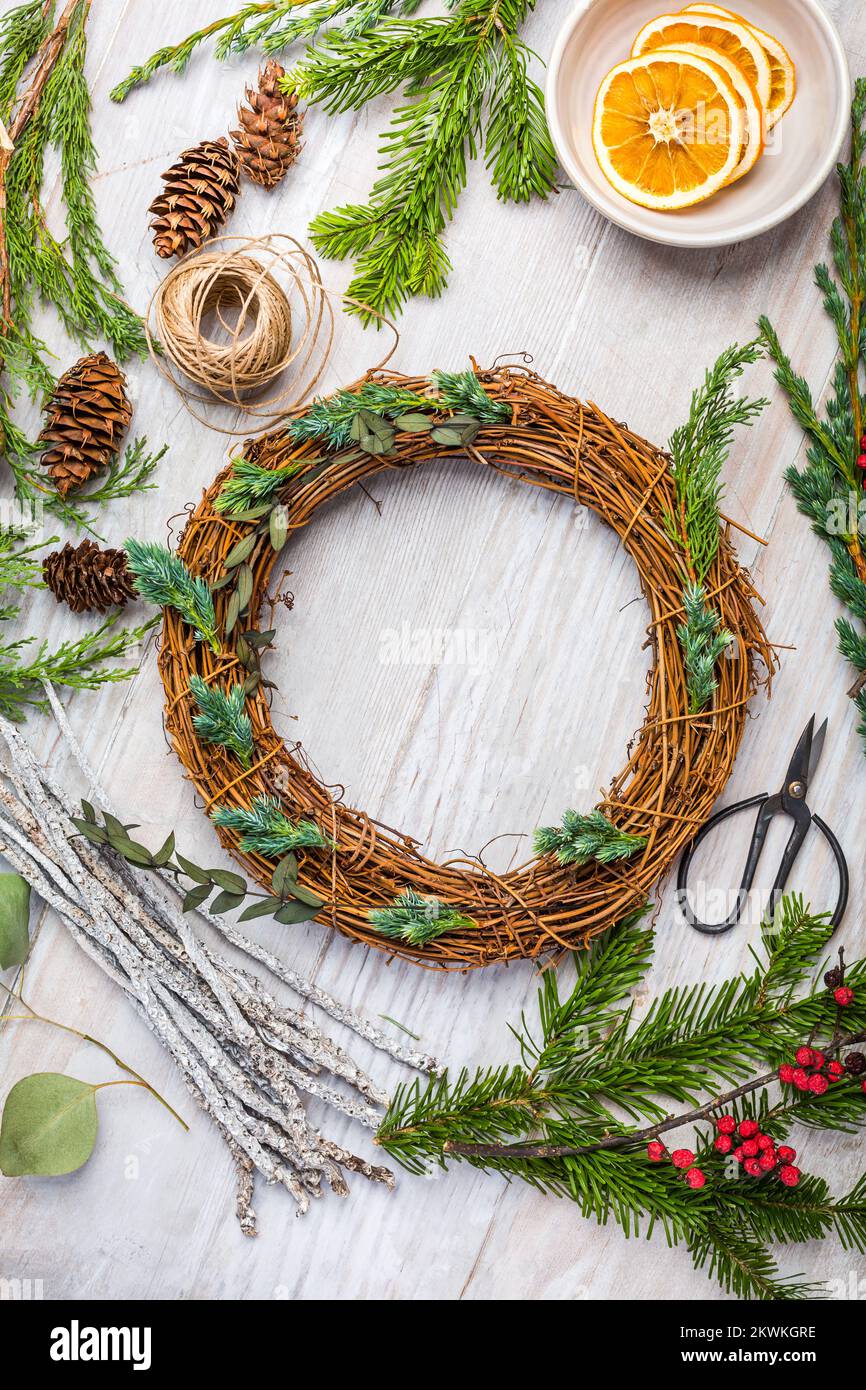 Steps of making christmas door wreath, top down view of florist's ...