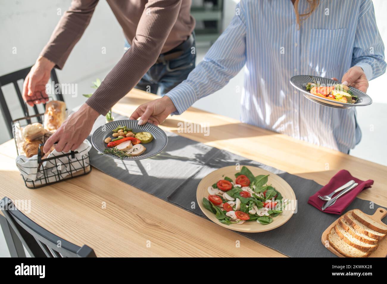Man serving the table before breakfast Stock Photo - Alamy