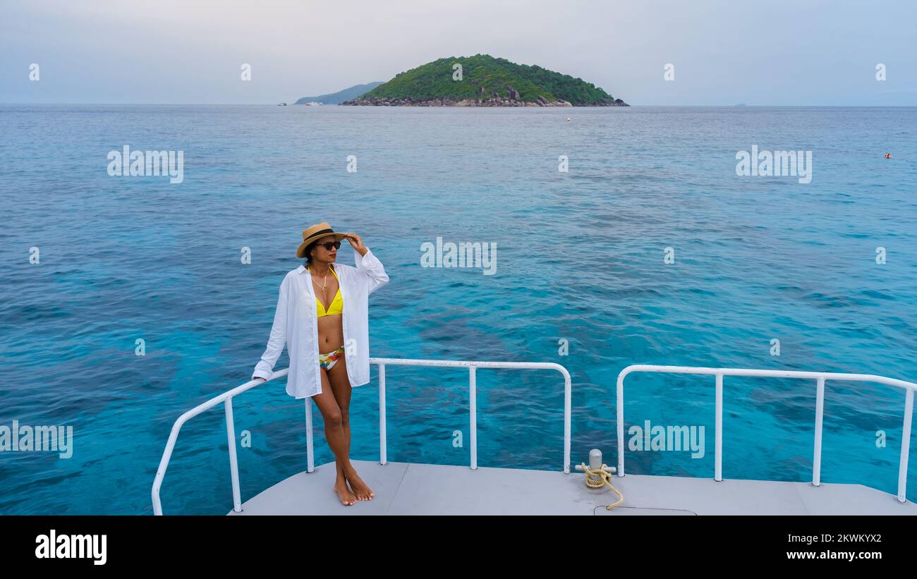 Asian Thai women on a boat trip at a catamaran near the Similan Islands ...