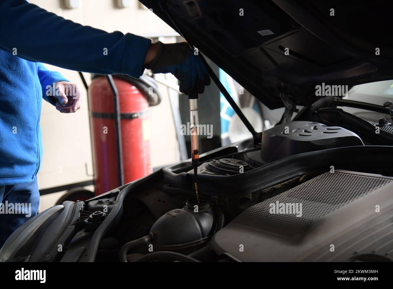 Sofia, Bulgaria - Nov 7 2022: A technician performing an engine oil ...