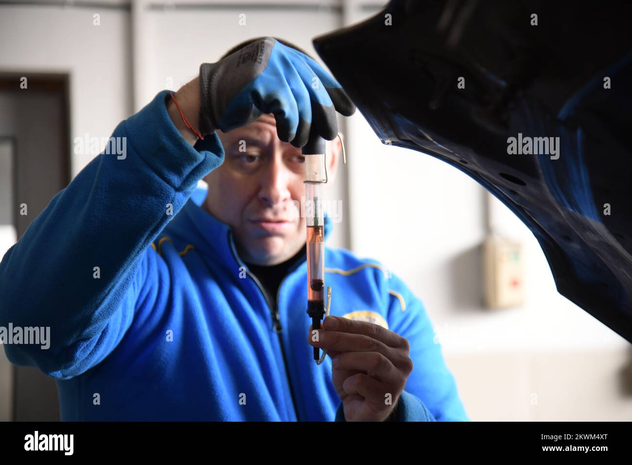 Sofia, Bulgaria - Nov 7 2022: A technician performing an engine oil ...