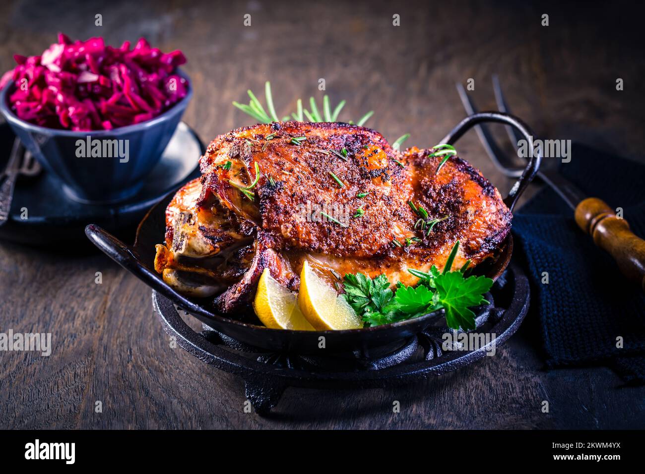 Roasted turkey knuckle with pickled red cabbage salad on wooden ...