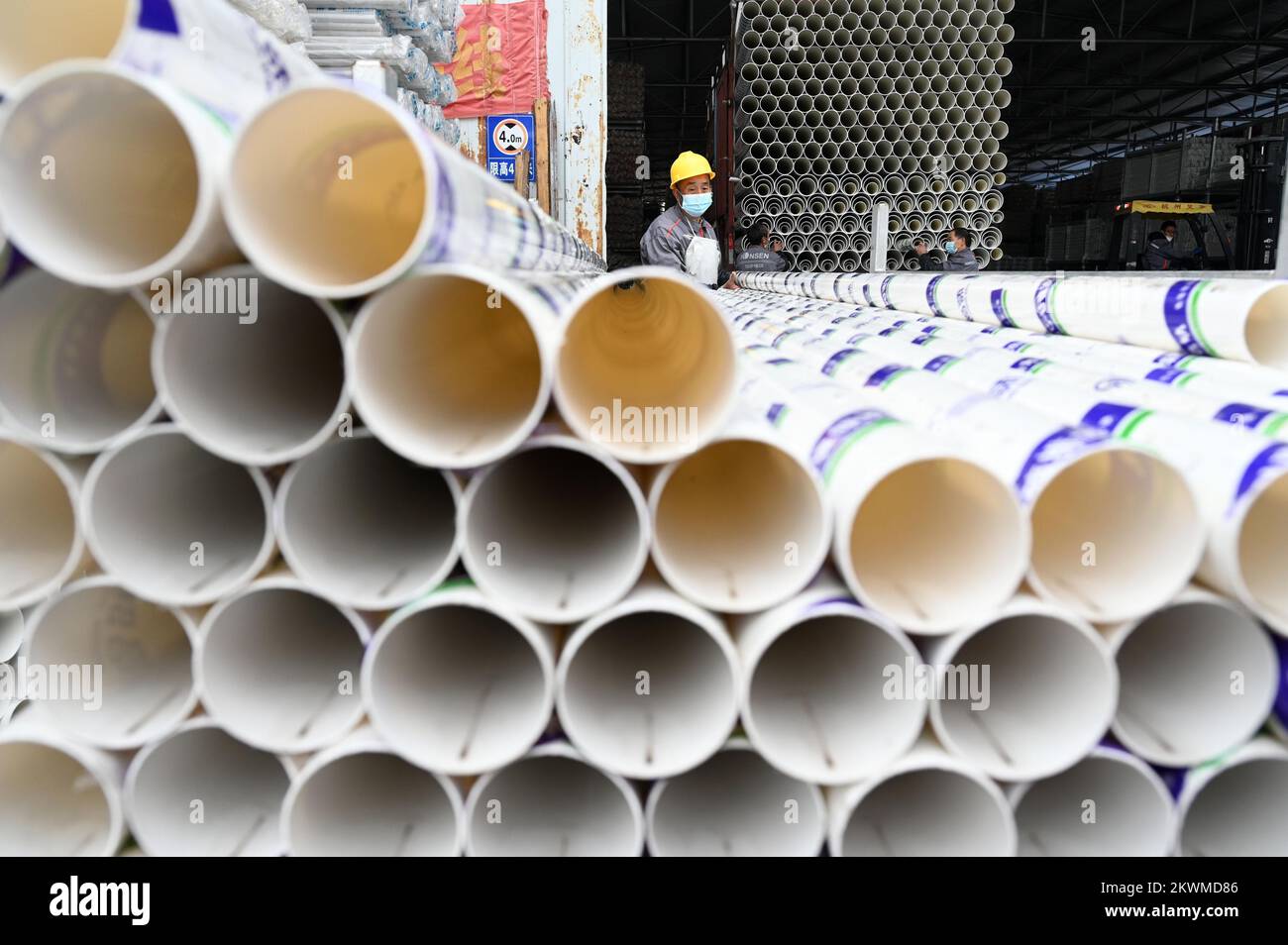 Workers are producing PVC pipes in a plastic products factory in ...