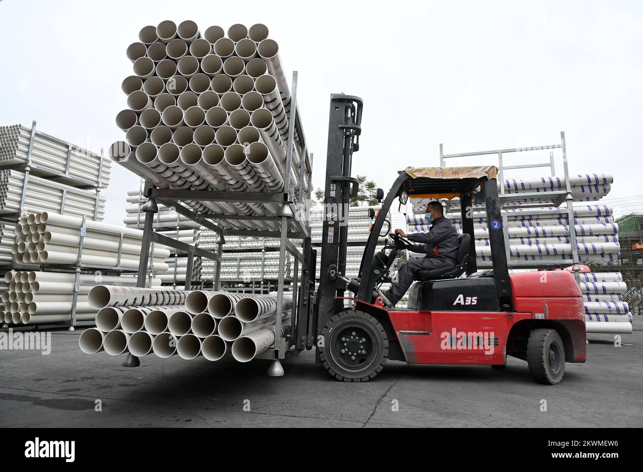 Workers are producing PVC pipes in a plastic products factory in ...