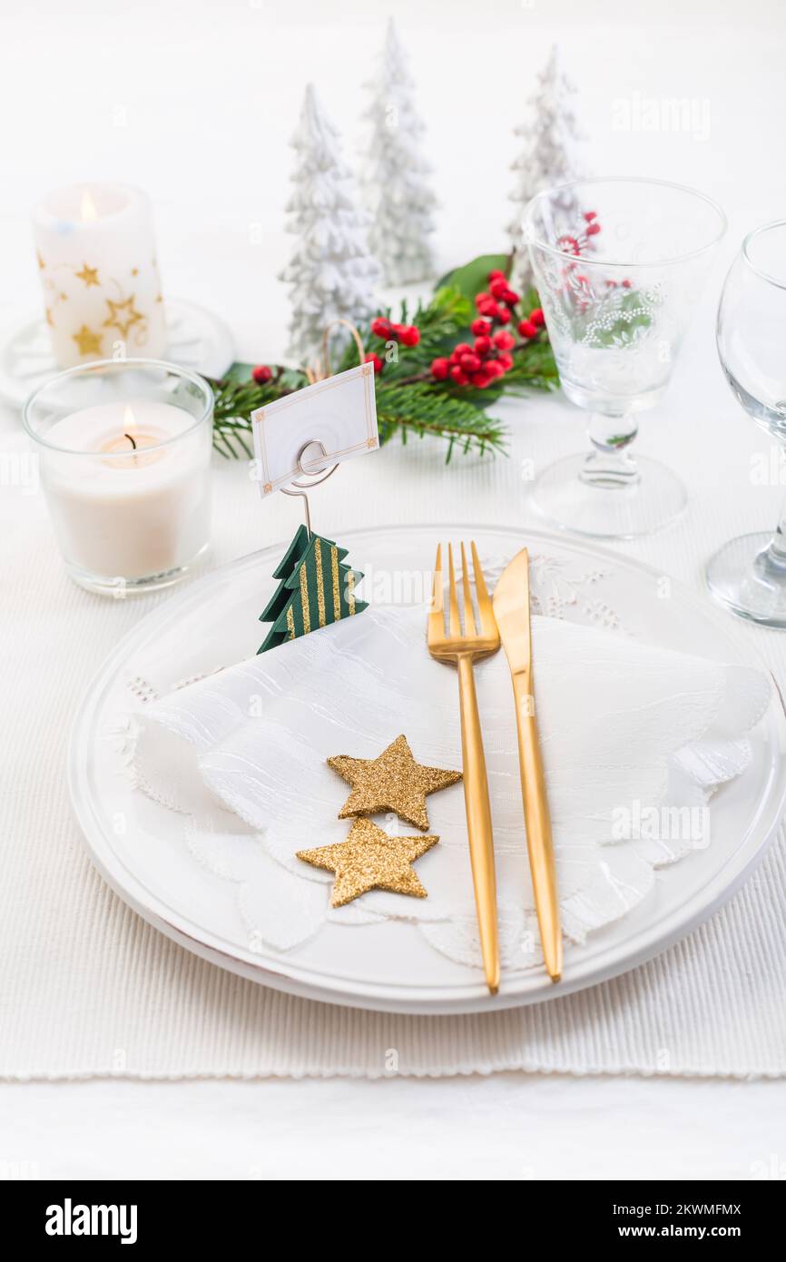 Christmas table setting with cutlery in white tone Stock Photo - Alamy