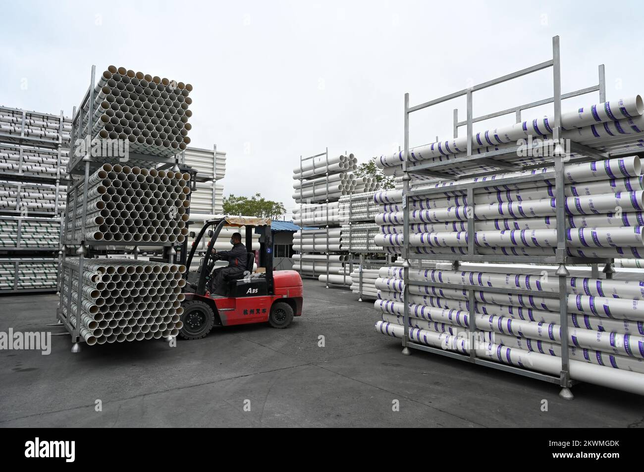 Workers are producing PVC pipes in a plastic products factory in ...