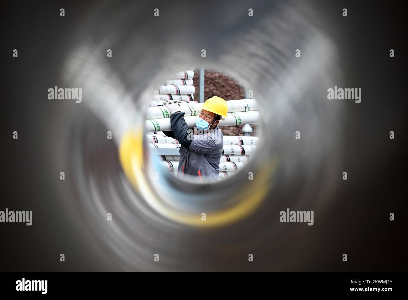 Workers are producing PVC pipes in a plastic products factory in ...