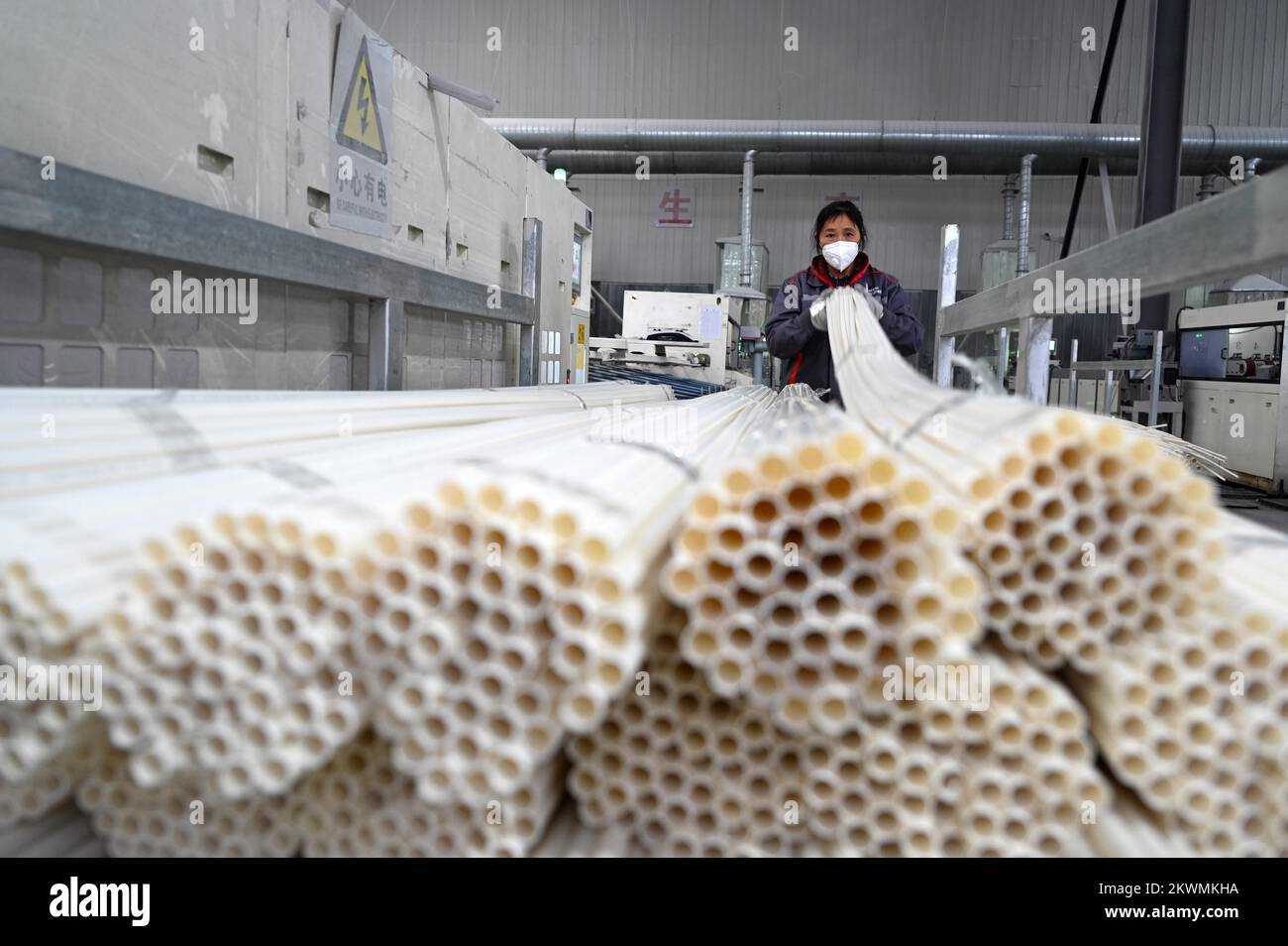 Workers are producing PVC pipes in a plastic products factory in ...