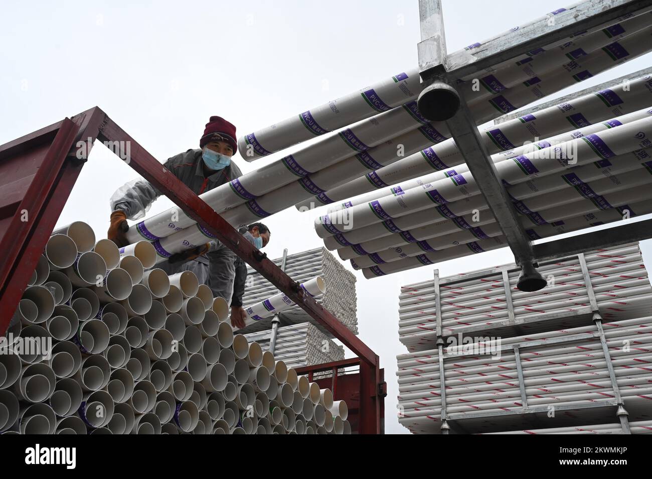 Workers are producing PVC pipes in a plastic products factory in ...