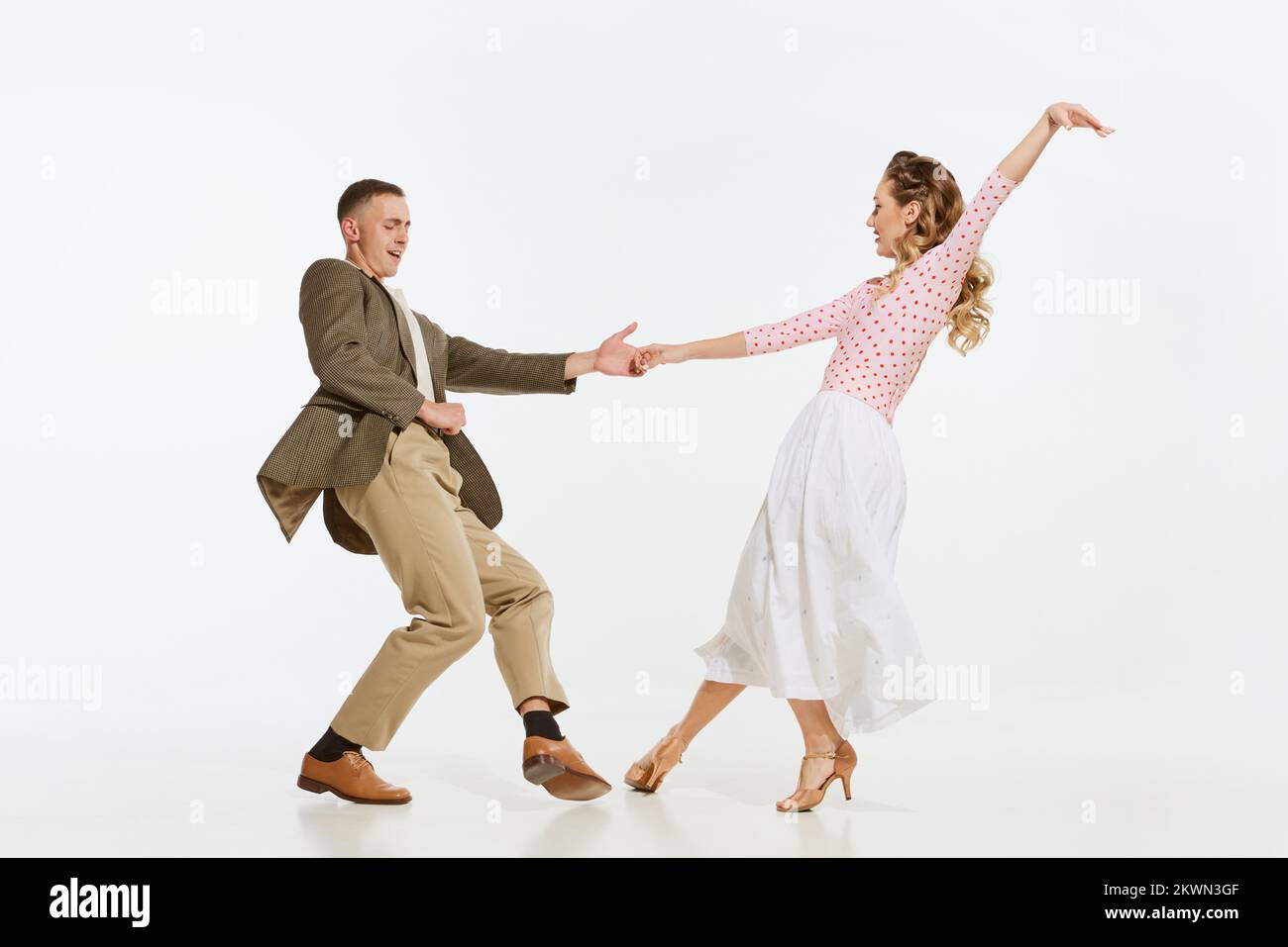 Two emotional dancers in vintage style clothes dancing swing dance ...