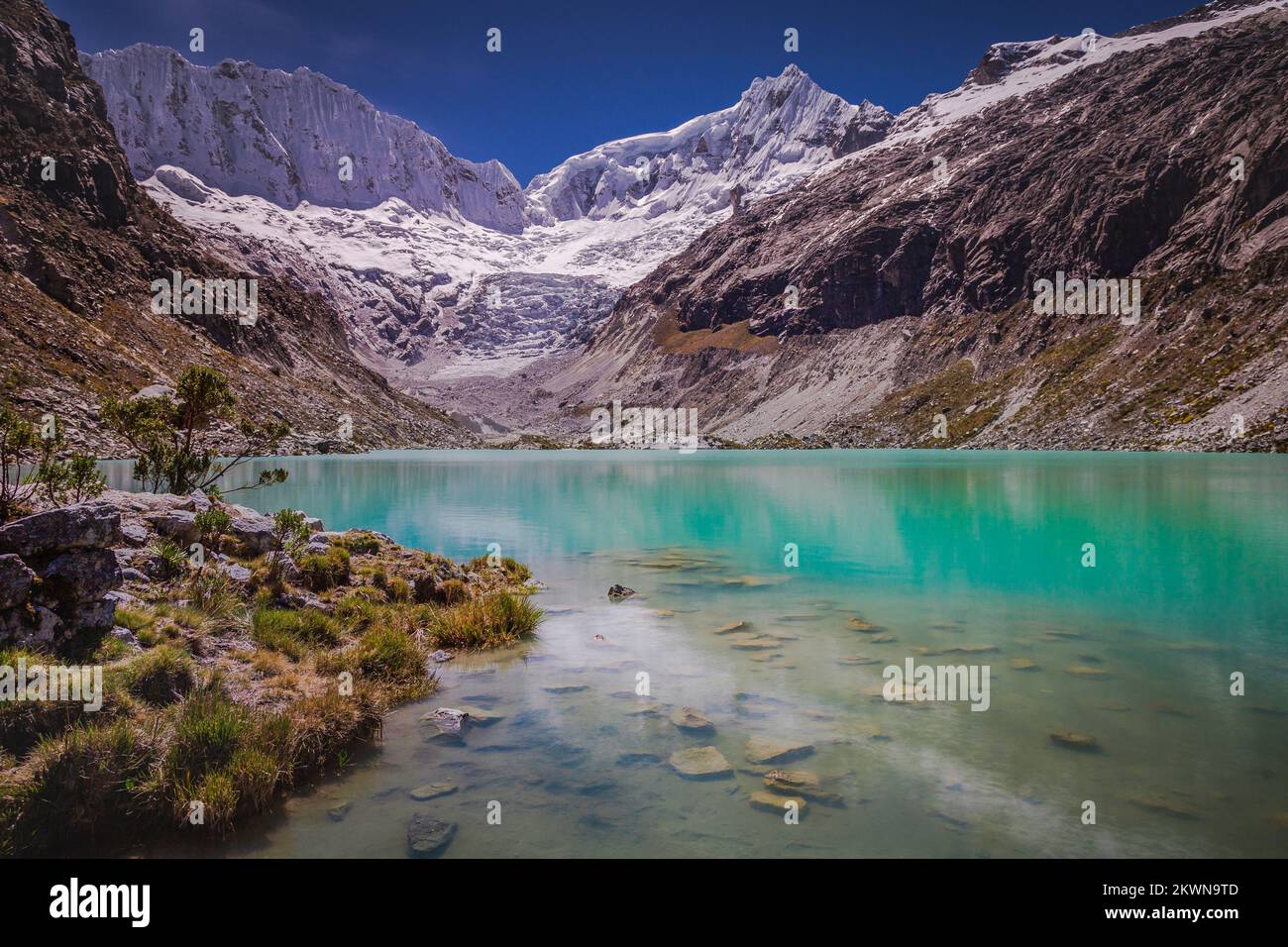 Llaca lake in Cordillera Blanca with snowcapped Andes, Ancash, Peru ...