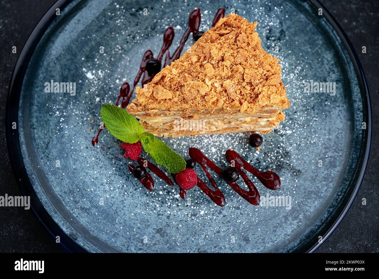 A piece of Napoleon cake with berries and mint Stock Photo - Alamy