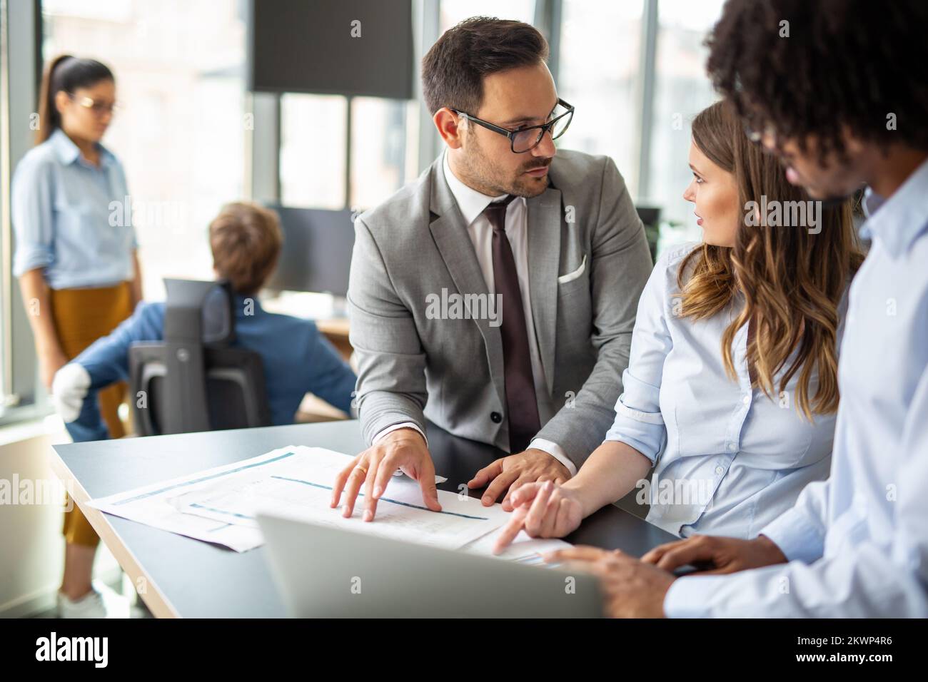 Group of successful business people meeting in office, sharing their ...