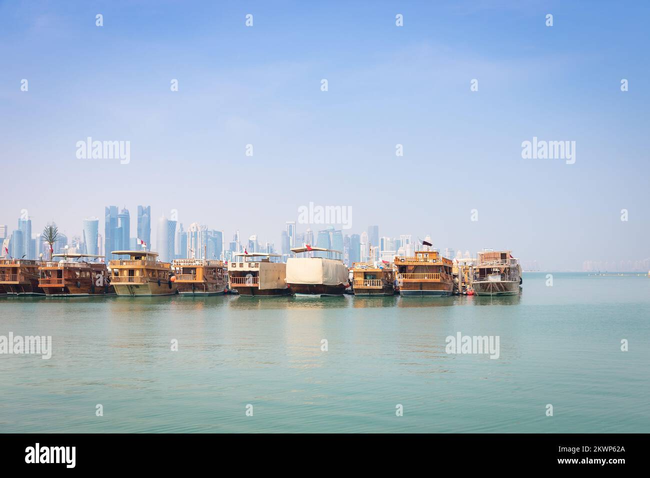 A line of traditional dhow boats docked in corniche, Doha, Qatar Stock ...