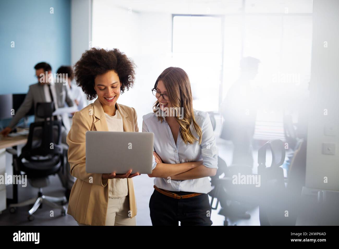 Happy multiethnic smiling business women working together in office Stock Photo - Alamy