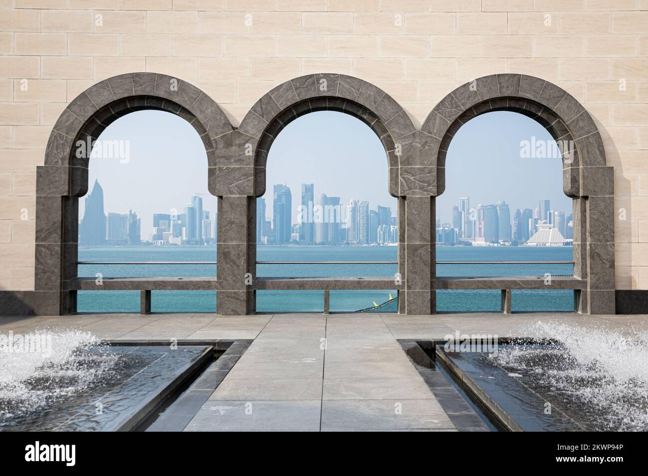 Doha skyline through the arches of the Museum of Islamic art, Qatar ...
