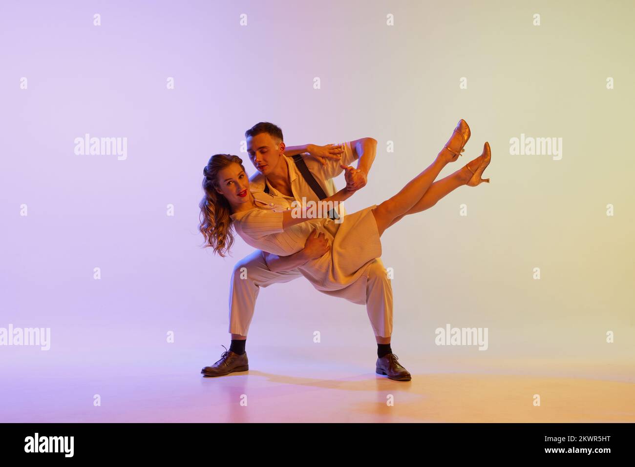 Beautiful girl and man in retro style costumes dancing incendiary ...