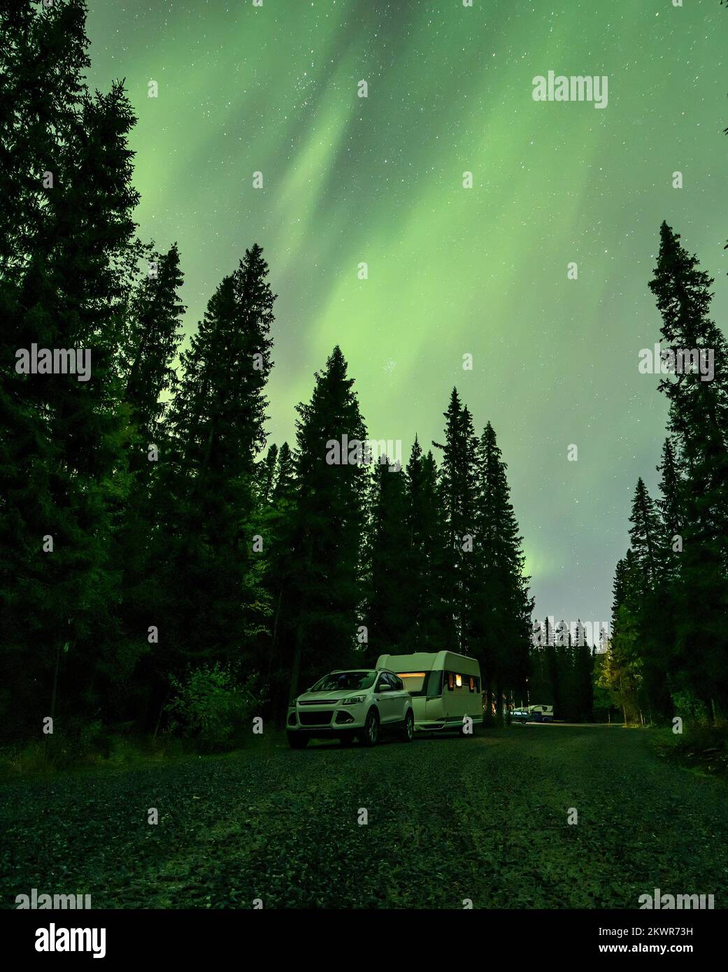 Aurora shining over Camping Caravan in Swedish forest landscape ...