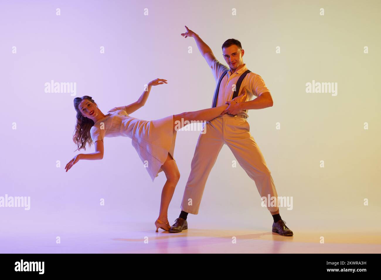 Incendiary dance. Emotional couple of dancers in retro style outfits dancing social dances ...