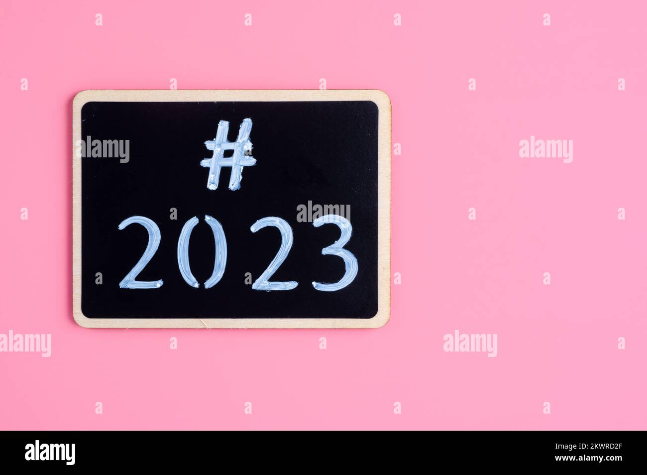 Hashtag welcome to 2023 chalkboard sign isolated on a pink background ...