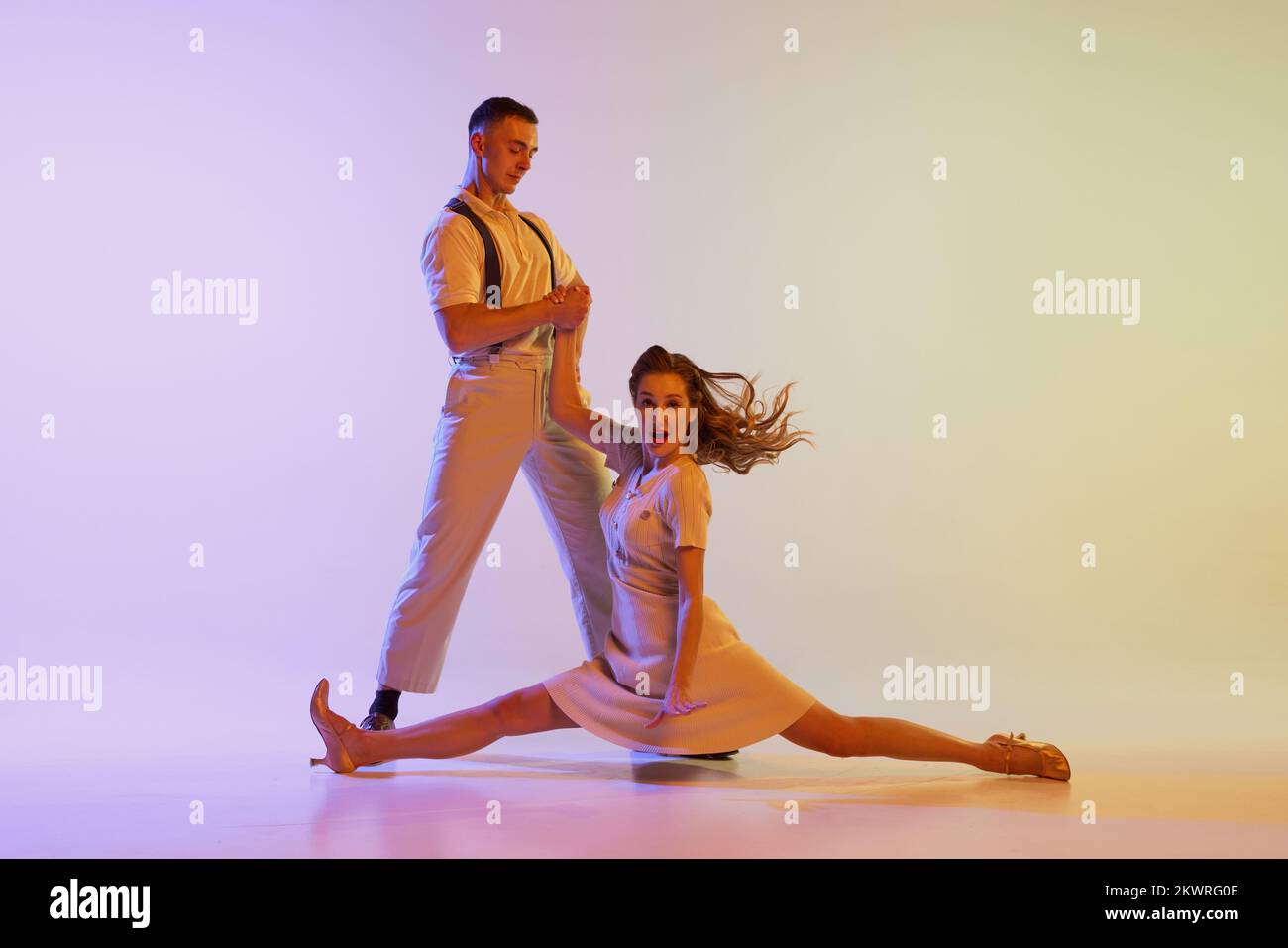 Incendiary dance. Emotional couple of dancers in retro style outfits dancing social dances ...