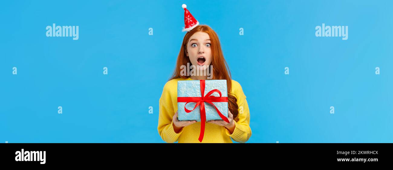 Surprised startled pretty redhead girl receive unexpected gift for ...