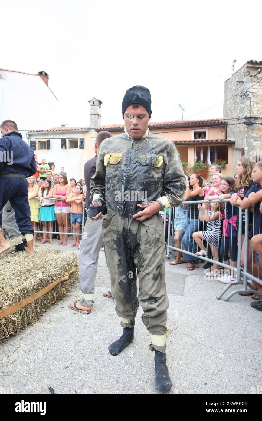 Men participate in the traditional competition of climbing up the ...