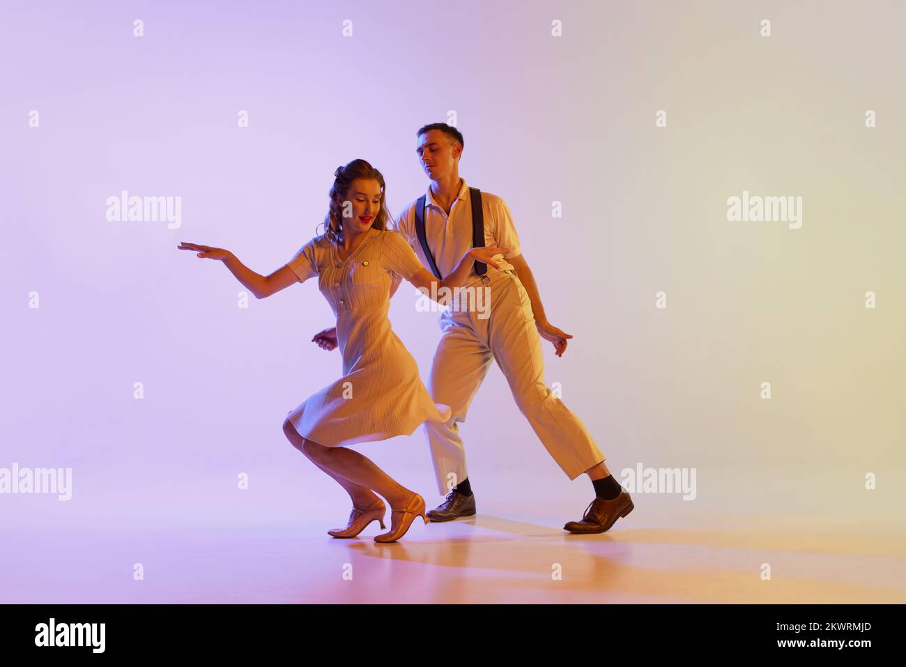 Incendiary dance. Emotional couple of dancers in retro style outfits dancing social dances ...