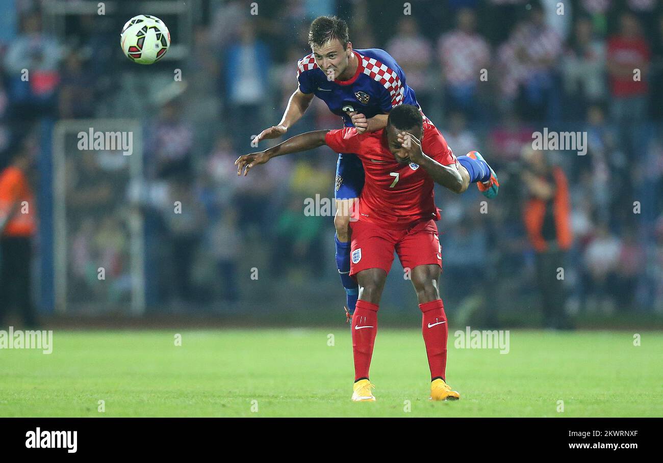 Croatia's Antonio Milic (top) and England's Saido Berahino in action ...