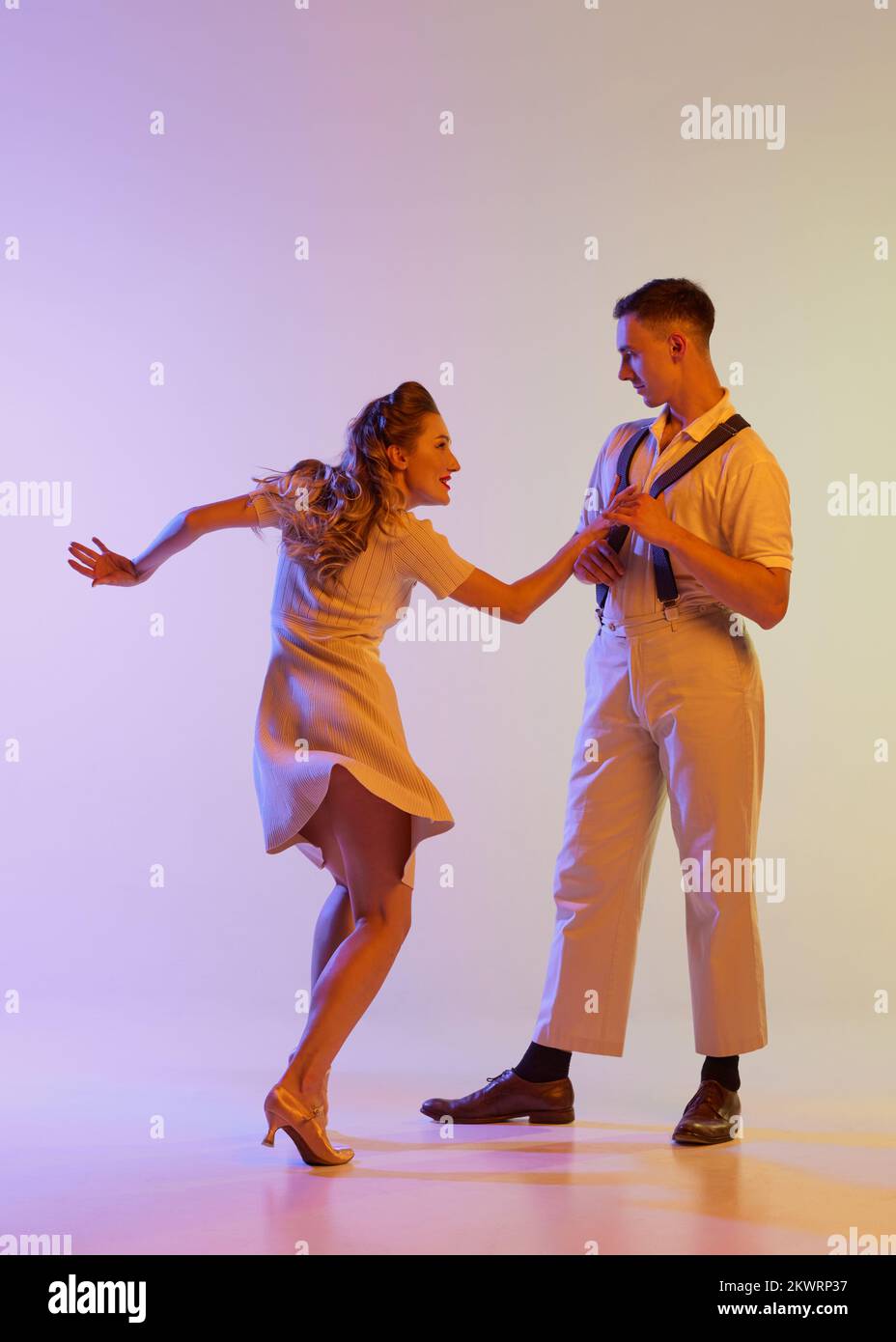 Incendiary dance. Emotional couple of dancers in retro style outfits dancing social dances ...