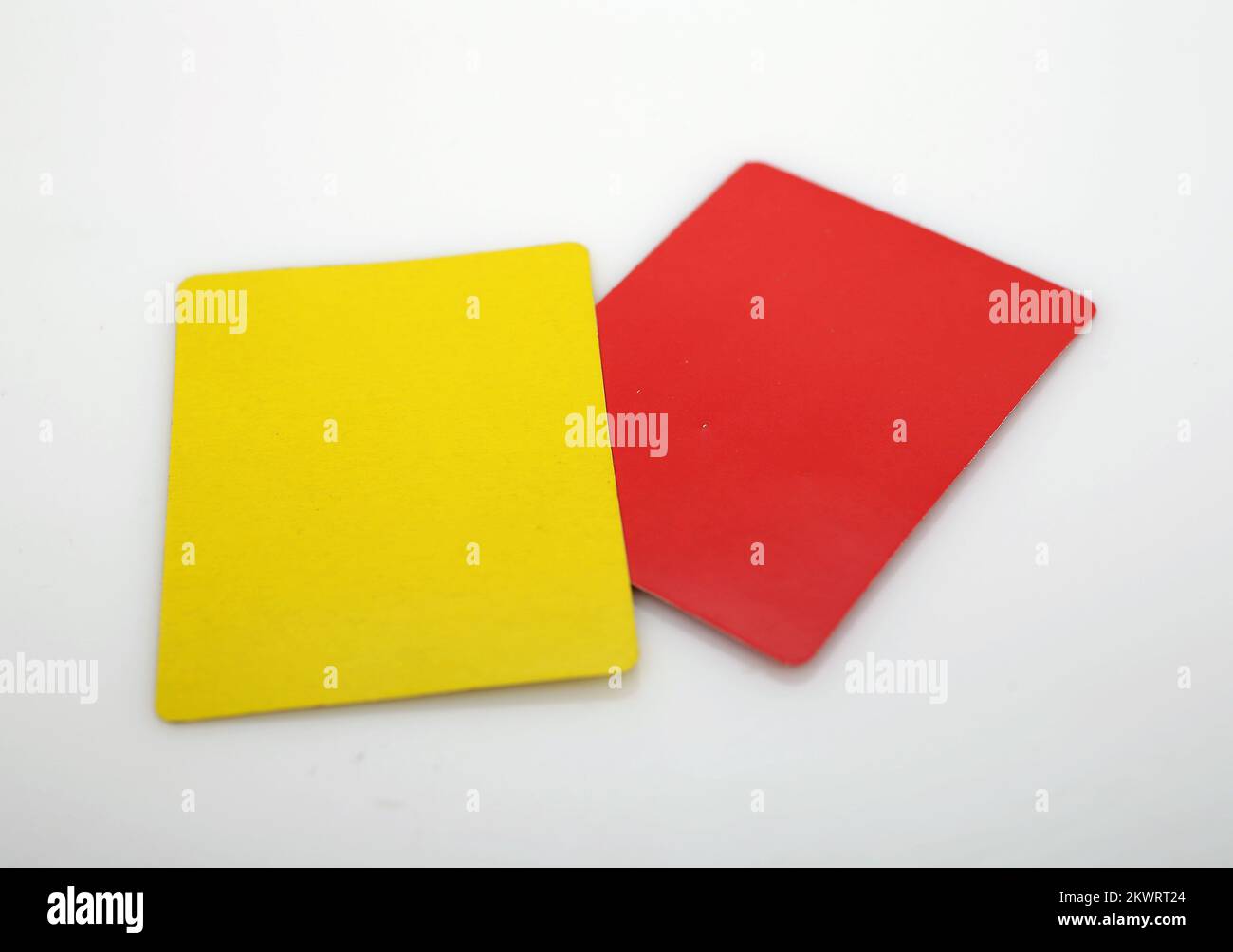A general view of a yellow and red card on a plain white background ...