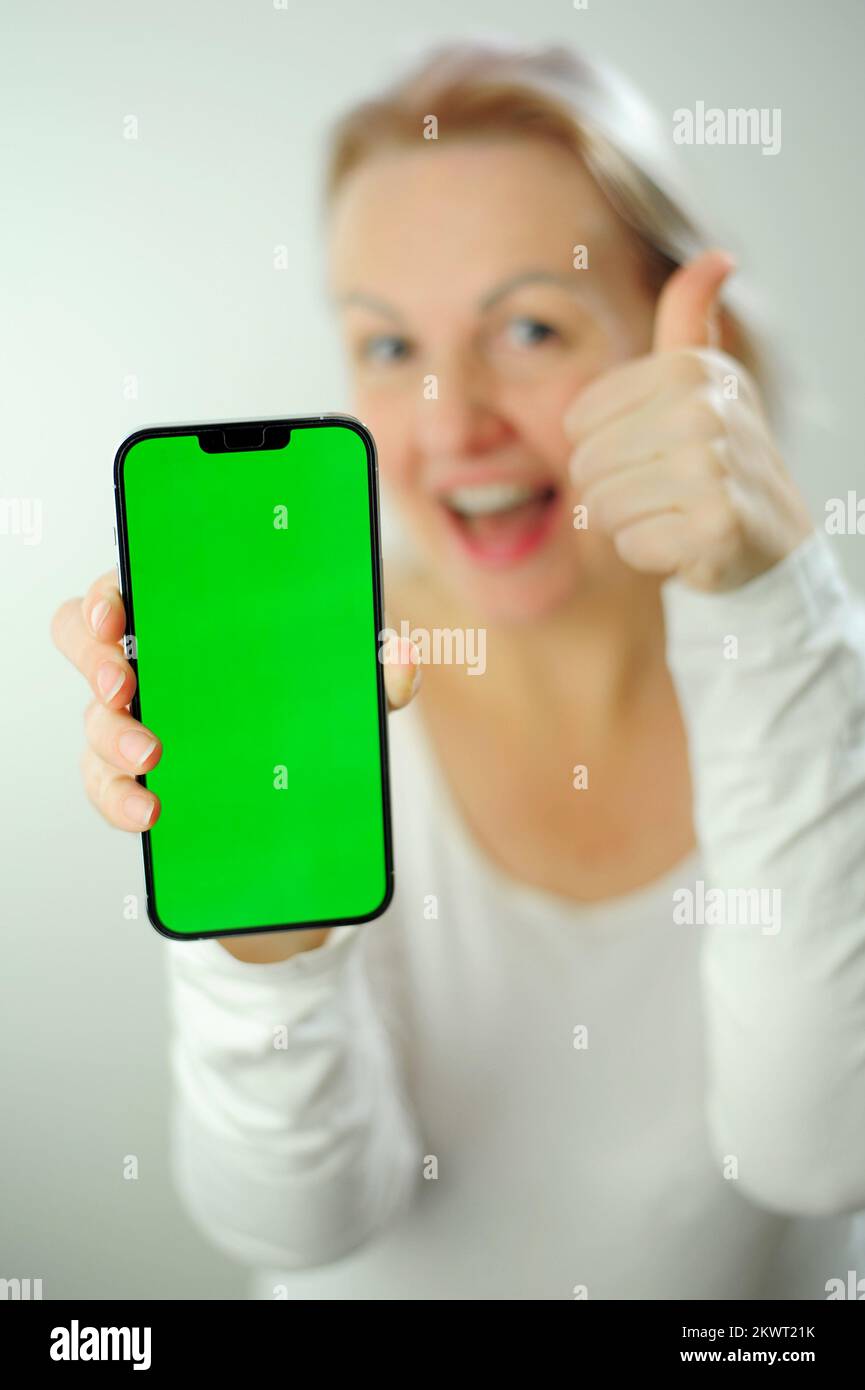 Photo of cheerful excited lady hold new model smart phone present good ...