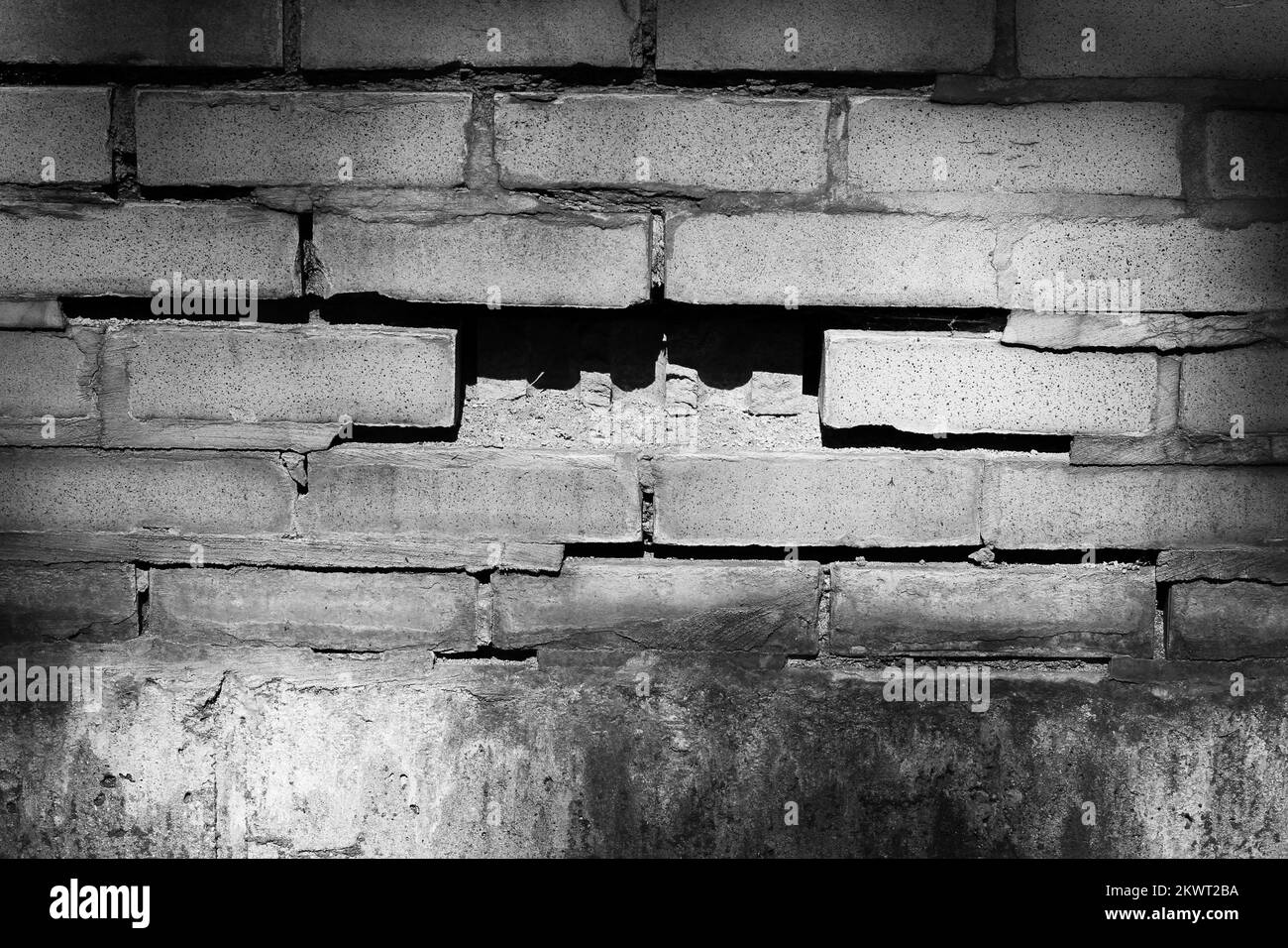 Typical common brick wall with a missing piece in a black and white ...