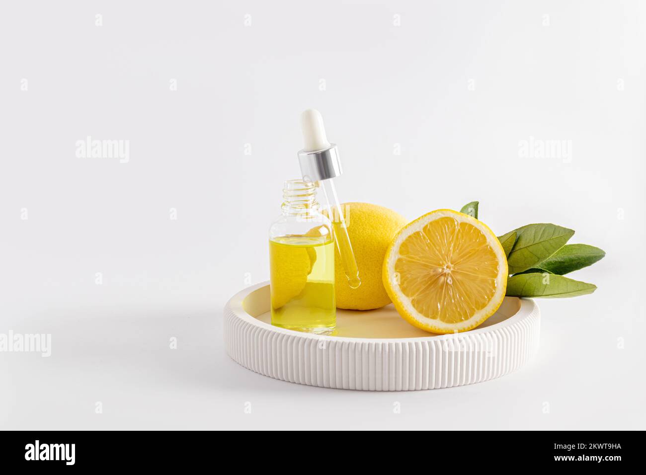 an open bottle with a brightening, moisturizing serum or cosmetic lemon ...