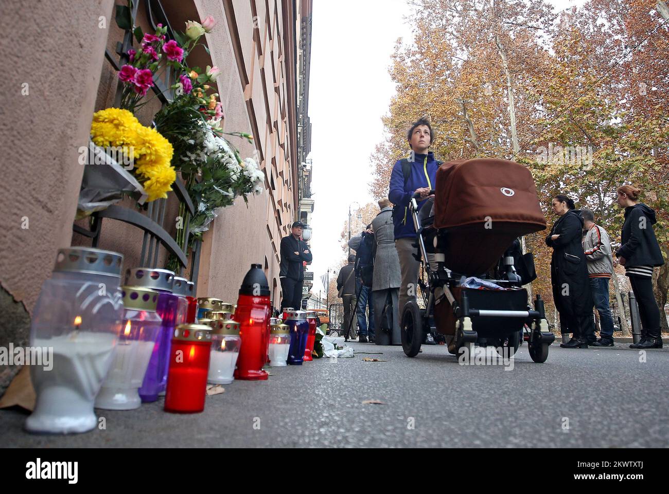 14.11.2015., Zagreb, Croatia - People put flowers and candles around ...