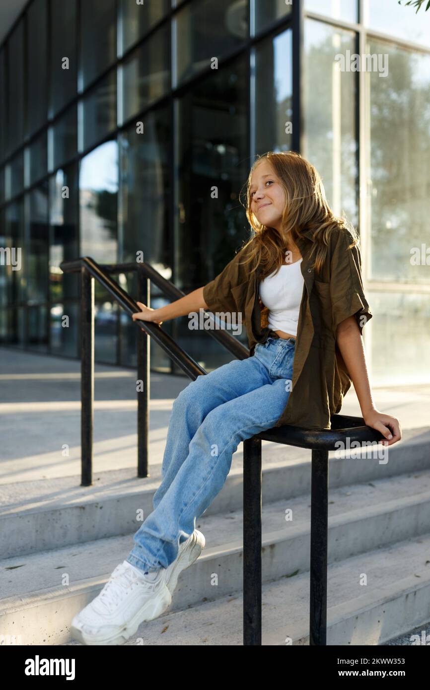 Girl sitting on stairs hi-res stock photography and images - Alamy
