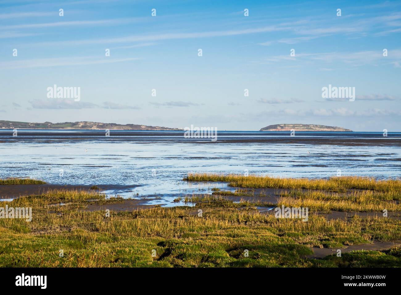 View across the seashore and Menai Strait to the Isle of Anglesey and ...