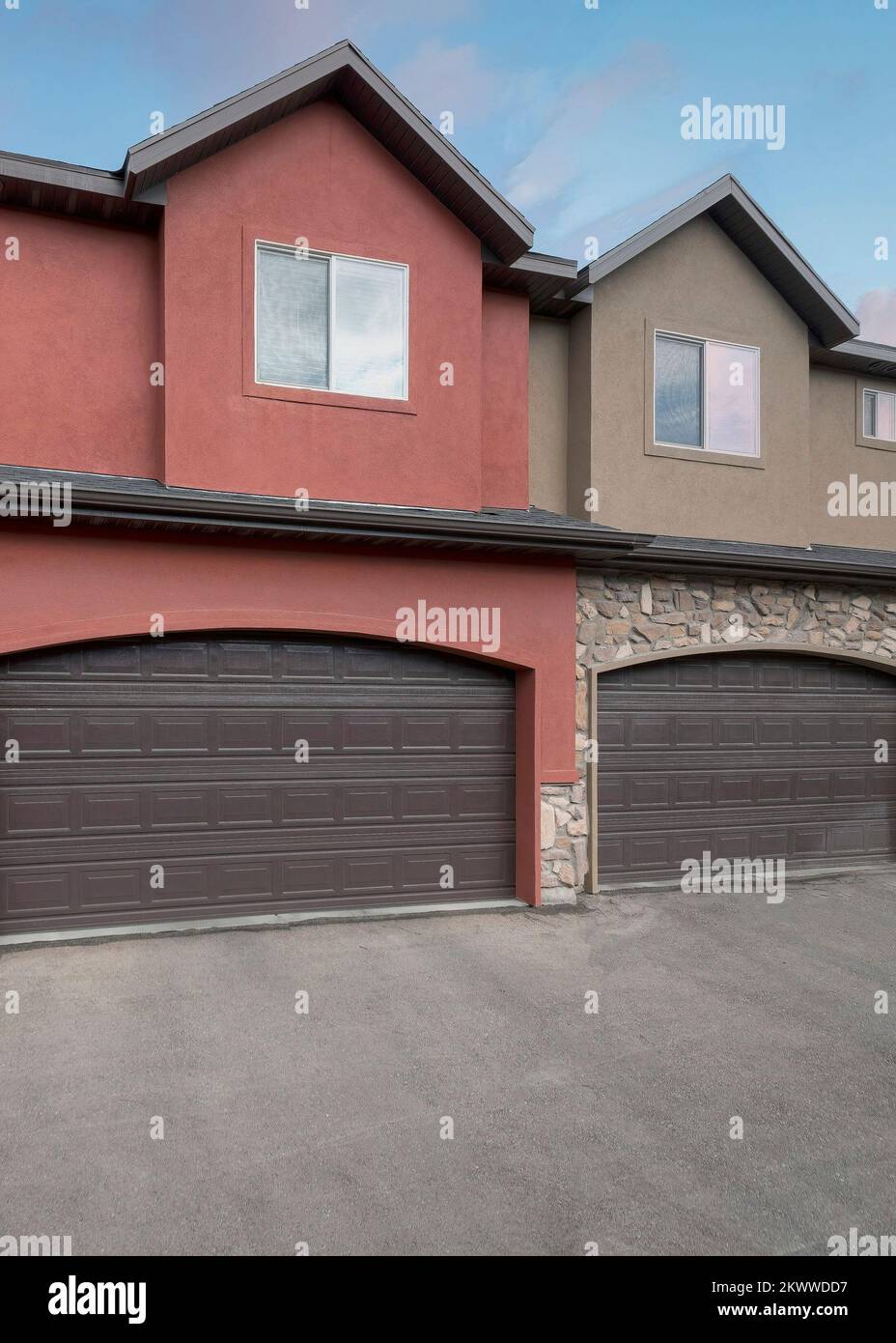 Vertical Puffy clouds at sunset Townhouse exterior with garage and ...