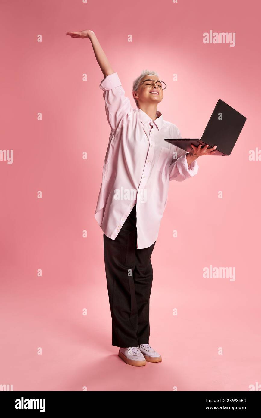 Portrait of young stylish woman with short hair posing in white shirt ...