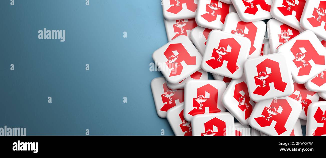 Logos of the German pharmacies (Apotheke) on a heap on a table. Copy ...