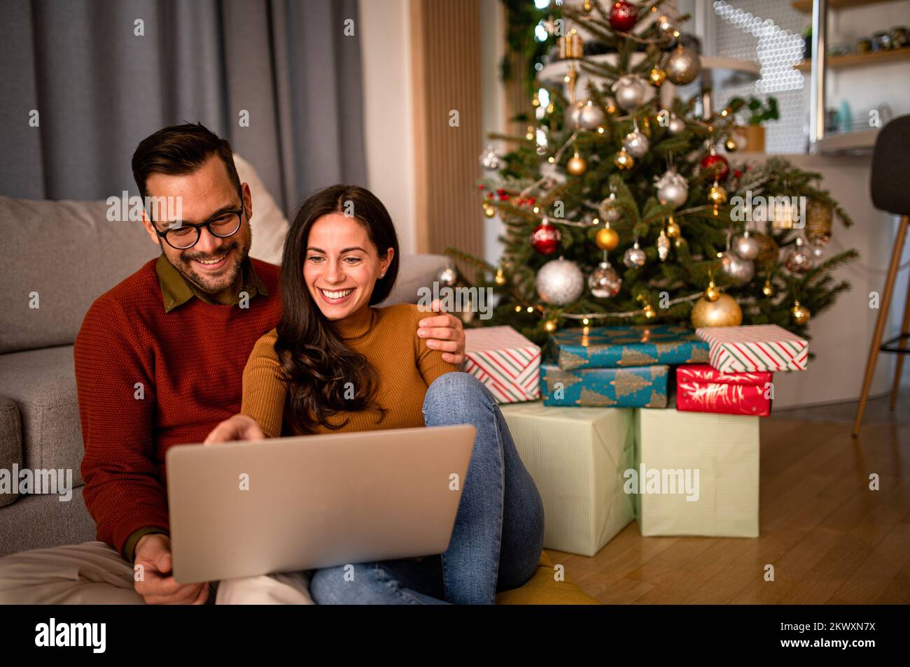 Christmas Online Shopping. Young couple with laptop buying online ...