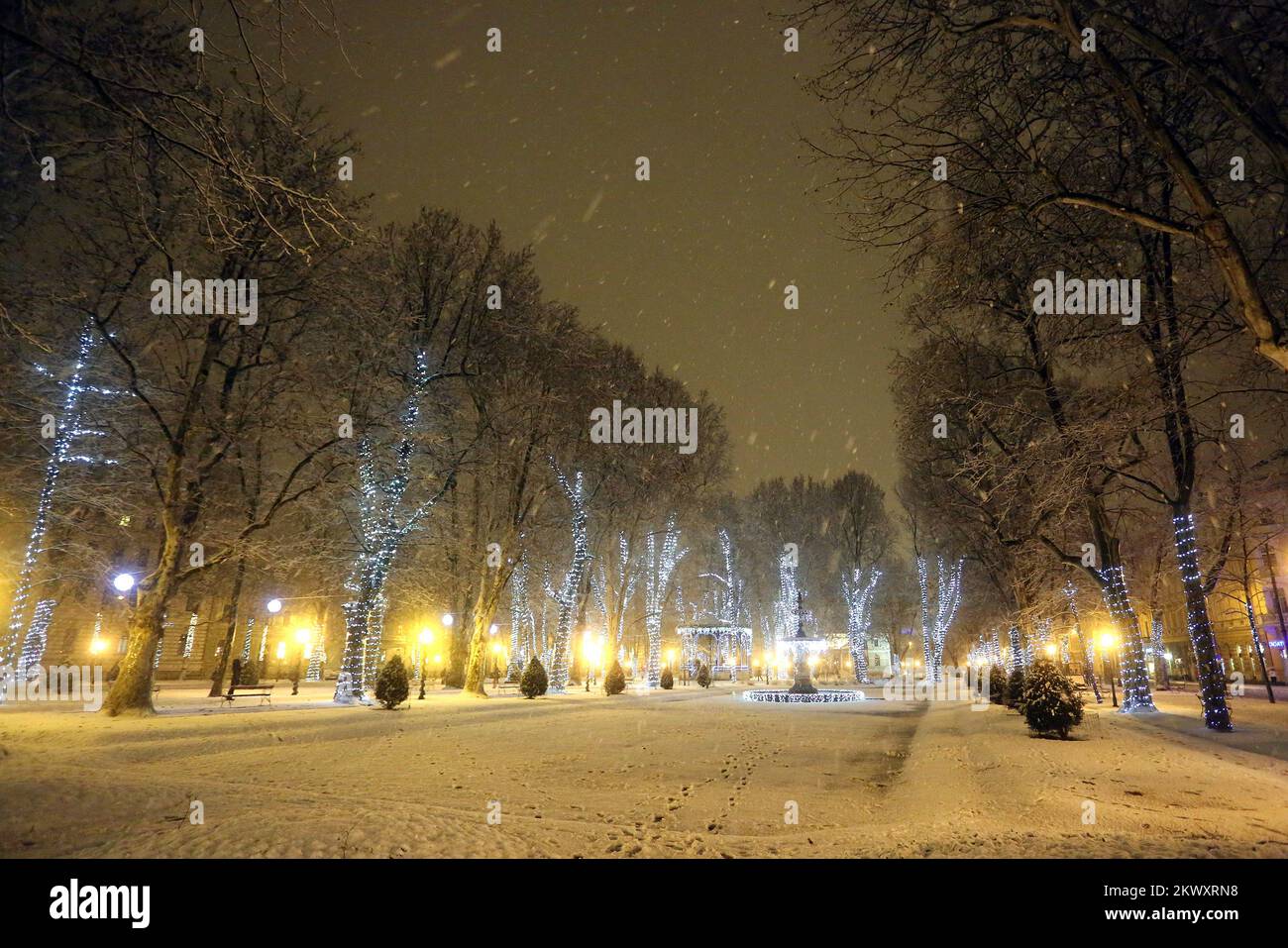 Snow has created idyllic night atmosphere in the city center. Park ...