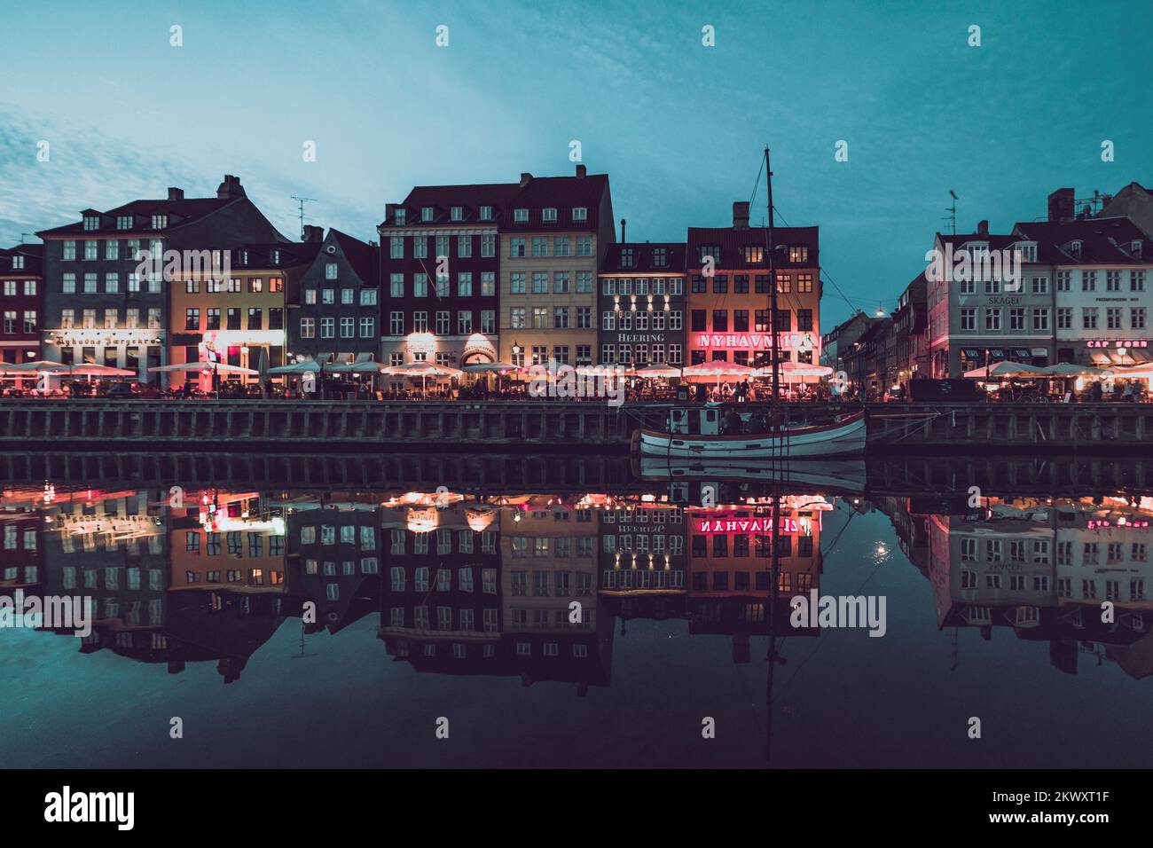 colorful buildings by the water, boat on the canal, Copenhagen city at ...