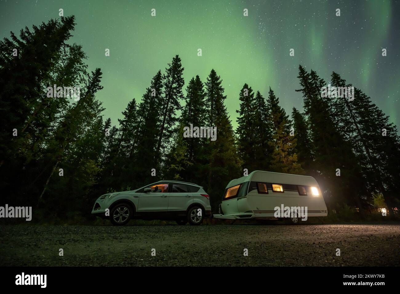 Aurora shining over Camping Caravan in Swedish forest landscape ...