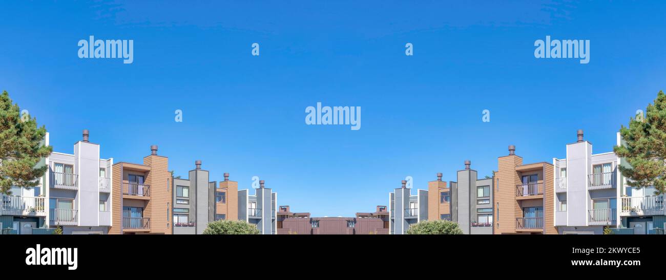 Abstract mirrored background Townhouses exterior with chimneys and ...