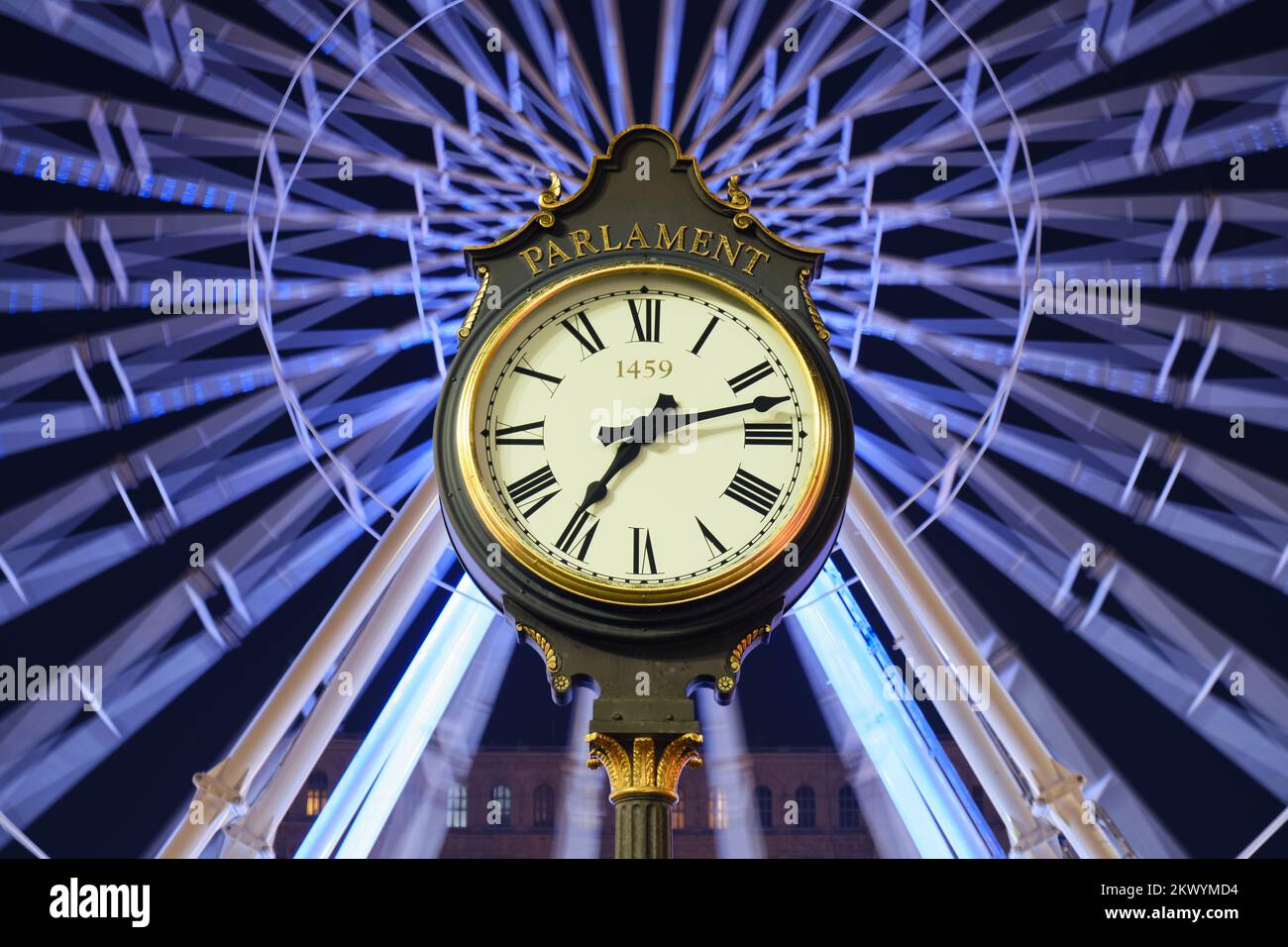 Parliament street clock at night with Christmas ferris wheel in the ... Parliament street clock at night with Christmas ferris wheel in the ...