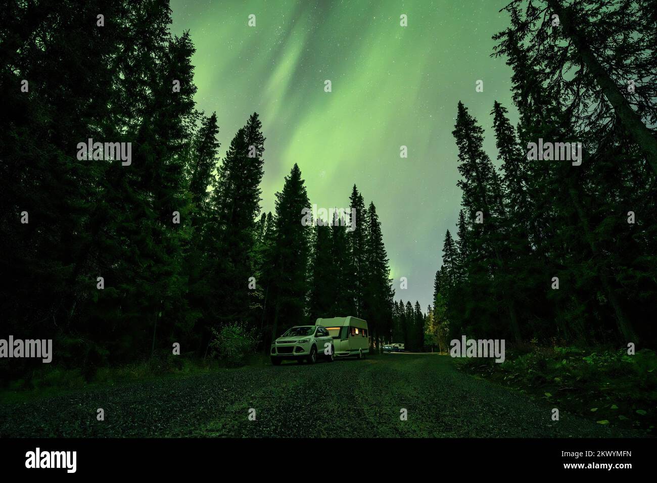 Aurora shining over Camping Caravan in Swedish forest landscape ...